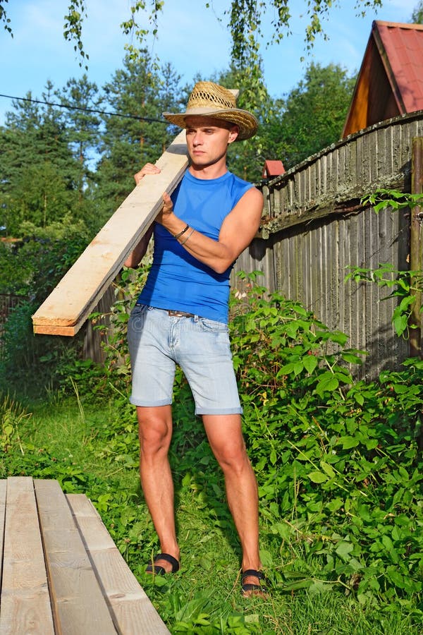 A Young Man with the Pine Board on His Shoulder about Piles of B Stock ...