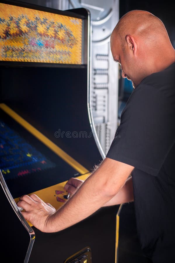 Man Playing Arcade Game Machine Stock Photo - Image of play, adult ...