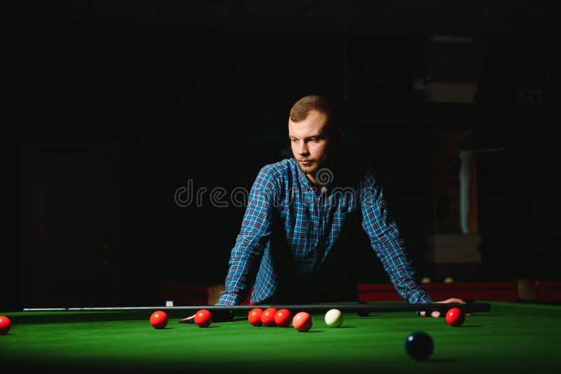 Young Man Playing Billiards in the Dark Billiard Club Stock Photo ...