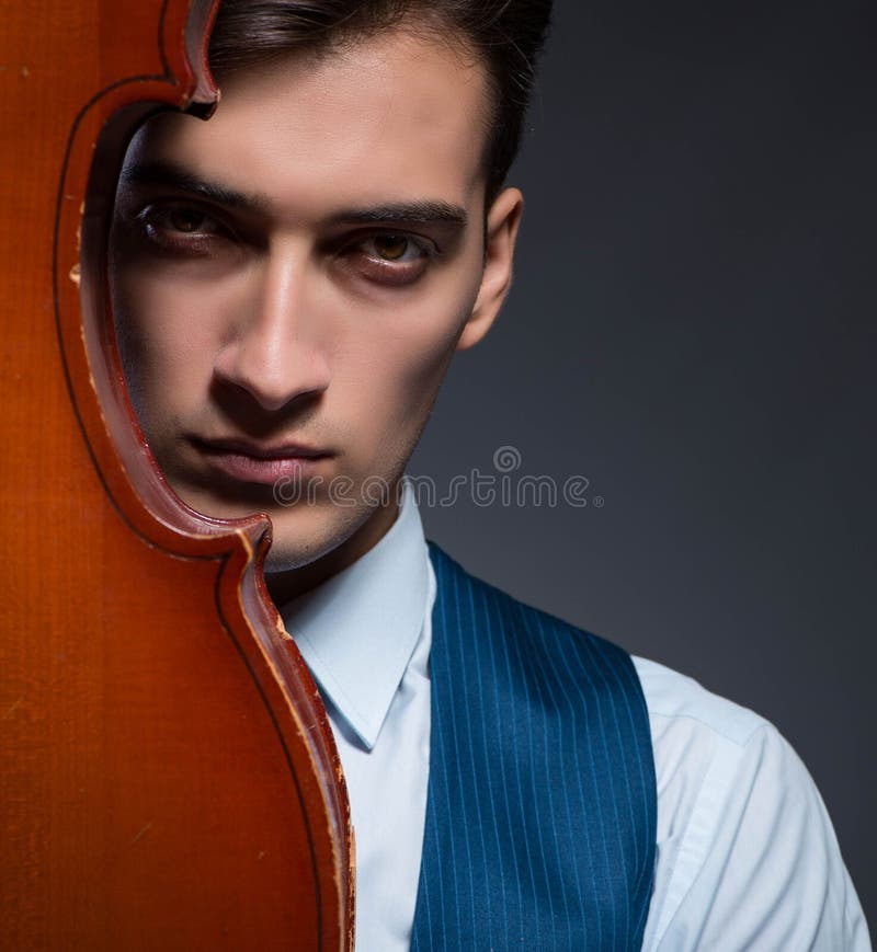 Young Man Playing Cello in Dark Room Stock Photo - Image of dark ...