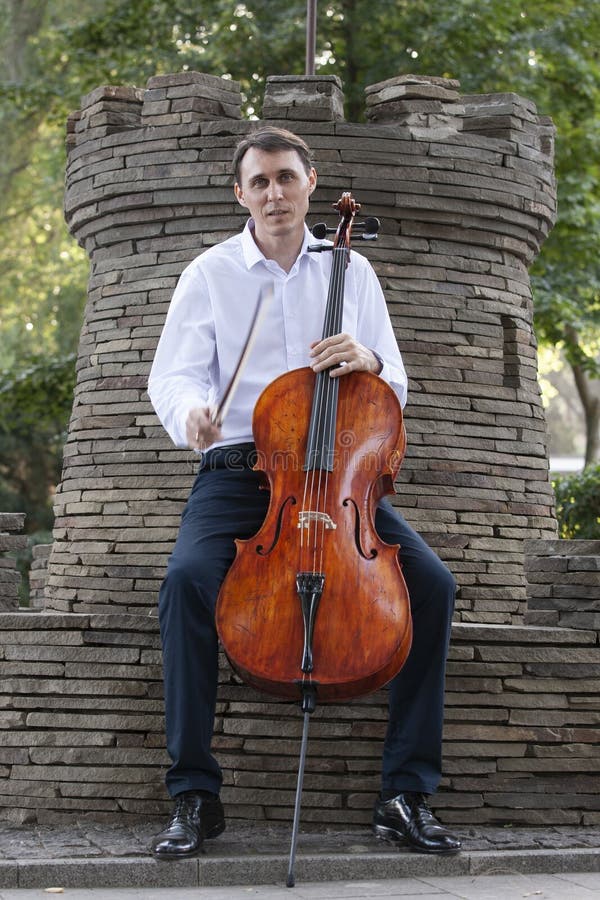 Young Man Playing Cello Outside. Cellist Playing Classical Music on ...