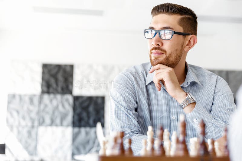 Young man playing chess stock photo. Image of people - 68572330