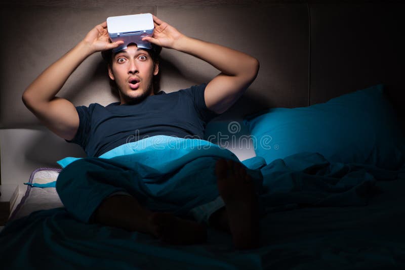 The Young Man Playing Computer Games at Night in Bed Stock Photo ...
