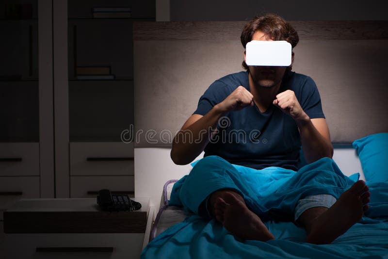 The Young Man Playing Computer Games at Night in Bed Stock Image ...