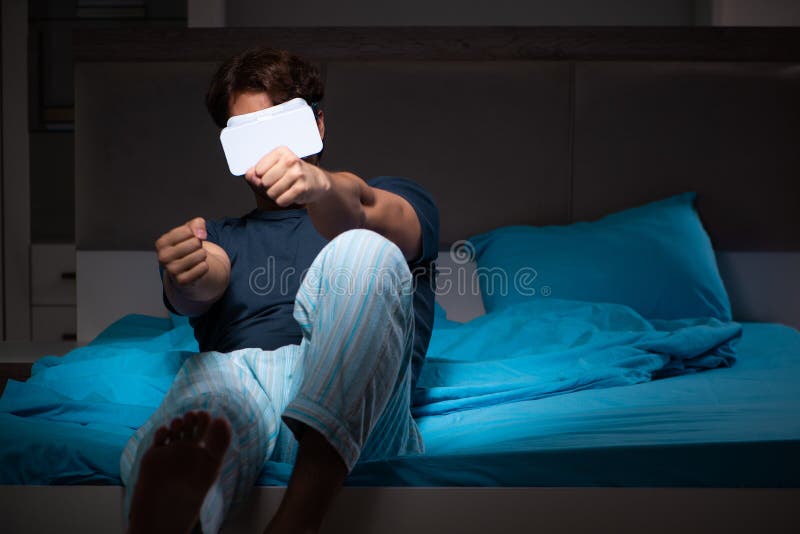 The Young Man Playing Computer Games at Night in Bed Stock Image ...