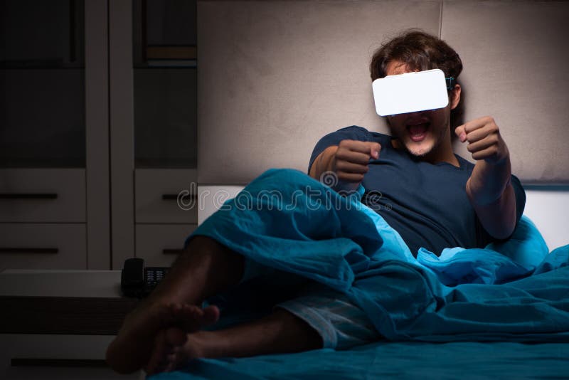 The Young Man Playing Computer Games at Night in Bed Stock Photo ...