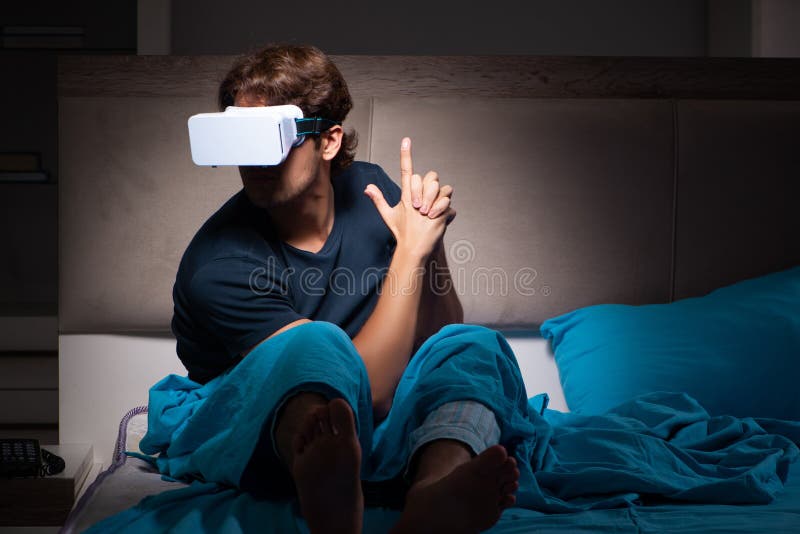 The Young Man Playing Computer Games at Night in Bed Stock Image ...