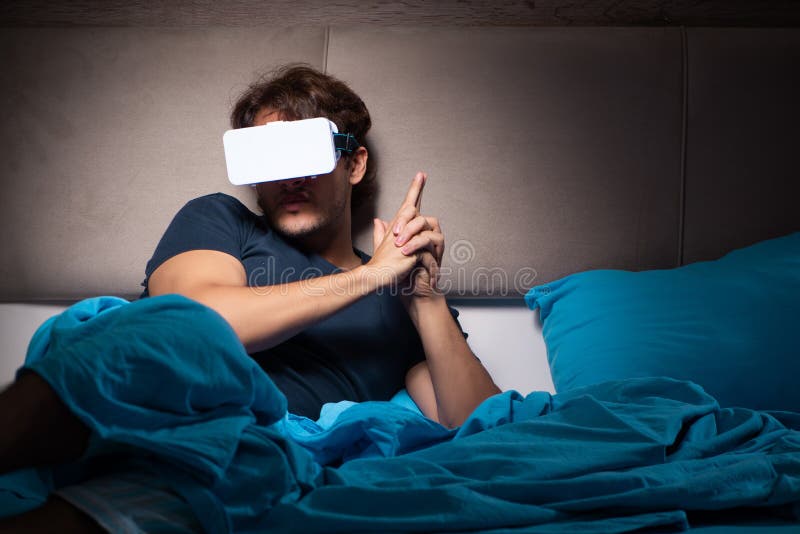 The Young Man Playing Computer Games at Night in Bed Stock Photo ...