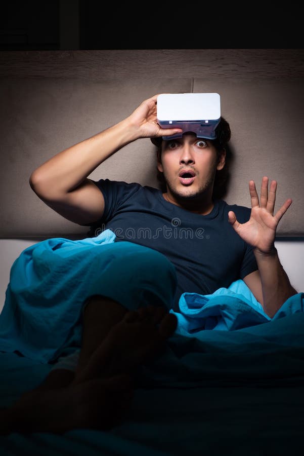 The Young Man Playing Computer Games at Night in Bed Stock Photo ...