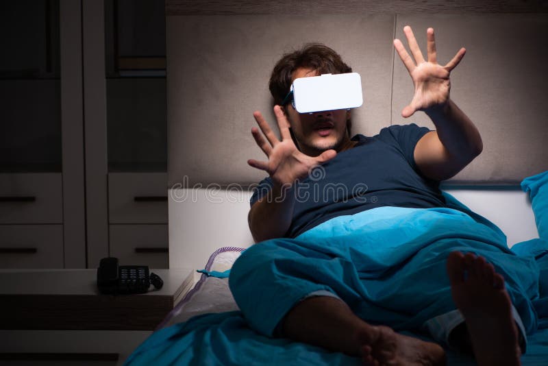 The Young Man Playing Computer Games at Night in Bed Stock Image ...
