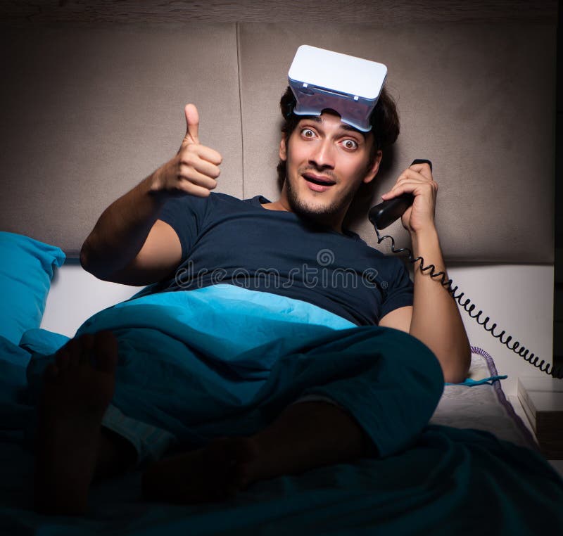 The Young Man Playing Computer Games at Night in Bed Stock Image ...