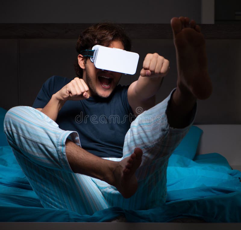 Young Man Playing Computer Games at Night in Bed Stock Image - Image of ...