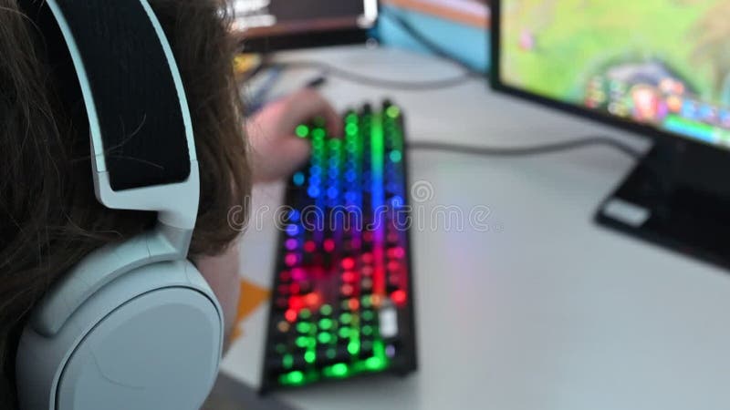 Young Man Playing Computer Games Using a Backlit Keyboard Stock Video ...