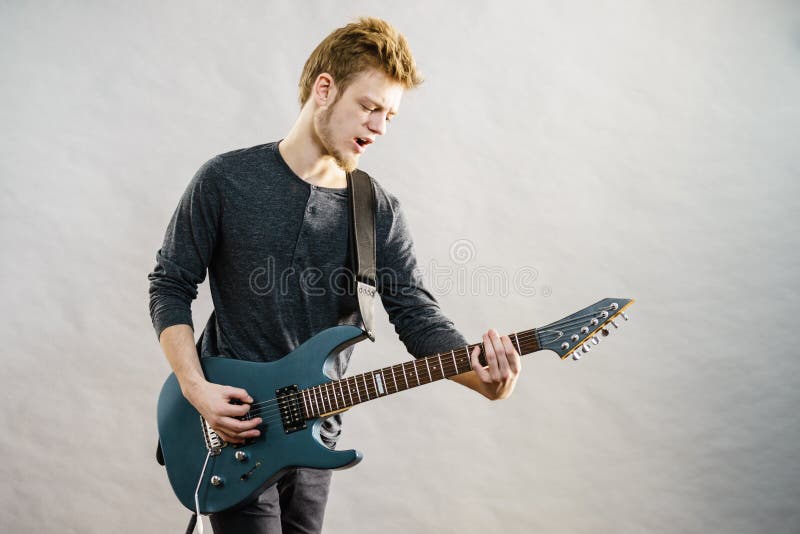 Young Man Playing Electric Guitar Stock Image - Image of male, music ... Young Man Playing Electric Guitar Stock Image - Image of male, music ...