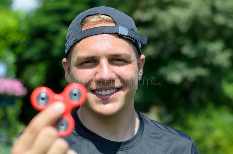 Young Man Playing with a Fidget Spinner Stock Photo - Image of training ...