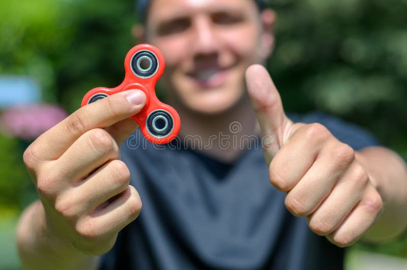 Young Man Playing with a Fidget Spinner Stock Image - Image of ...