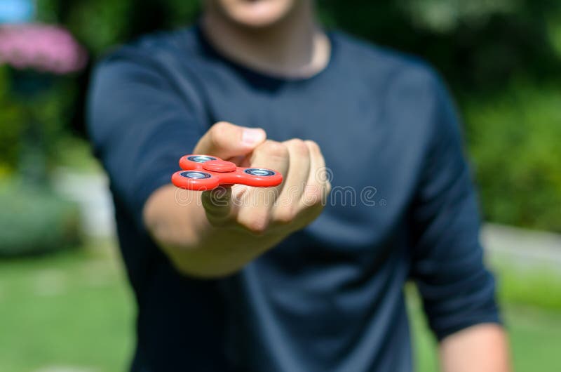 Young Man Playing with a Fidget Spinner Stock Photo - Image of training ...