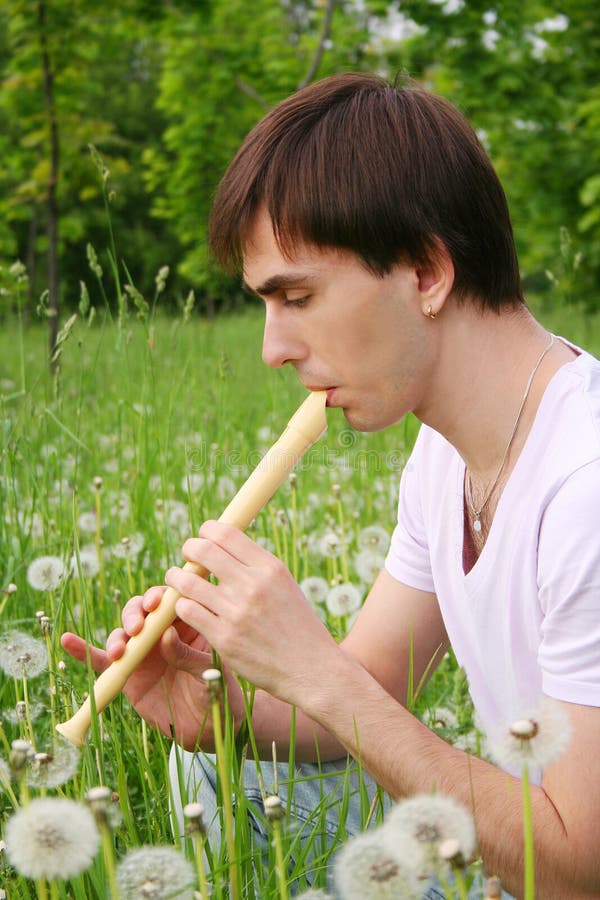 Young Man Playing on Flute Side View Stock Image - Image of sound ...
