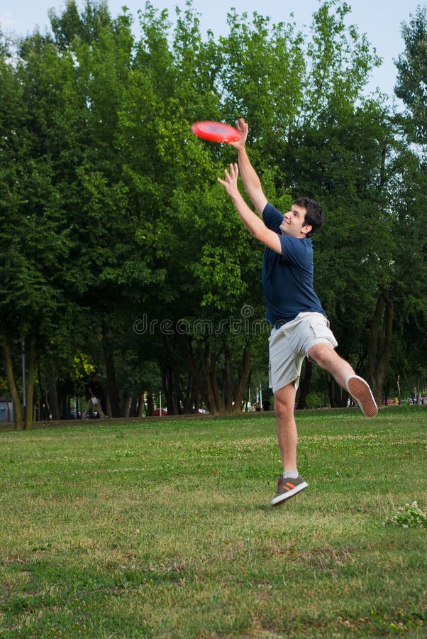 Young Man Playing Frisbee Outdoors Stock Photo - Image of grass ...