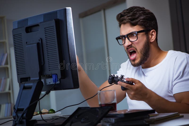 The Young Man Playing Games Long Hours Late in the Office Stock Image ...