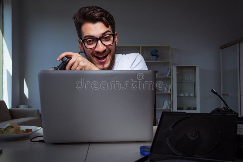 The Young Man Playing Games Long Hours Late in the Office Stock Photo ...