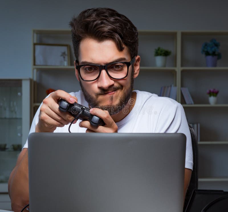 Young Man Playing Games Long Hours Late in the Office Stock Photo ...