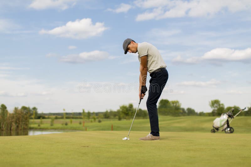 Young man playing golf stock photo. Image of leisure - 44156098