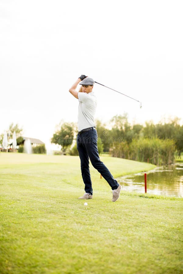 Young man playing golf stock photo. Image of play, grass - 65309220