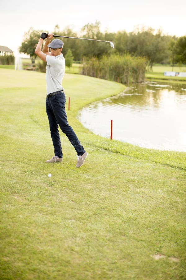 Young man playing golf stock photo. Image of color, caucasian - 65539892