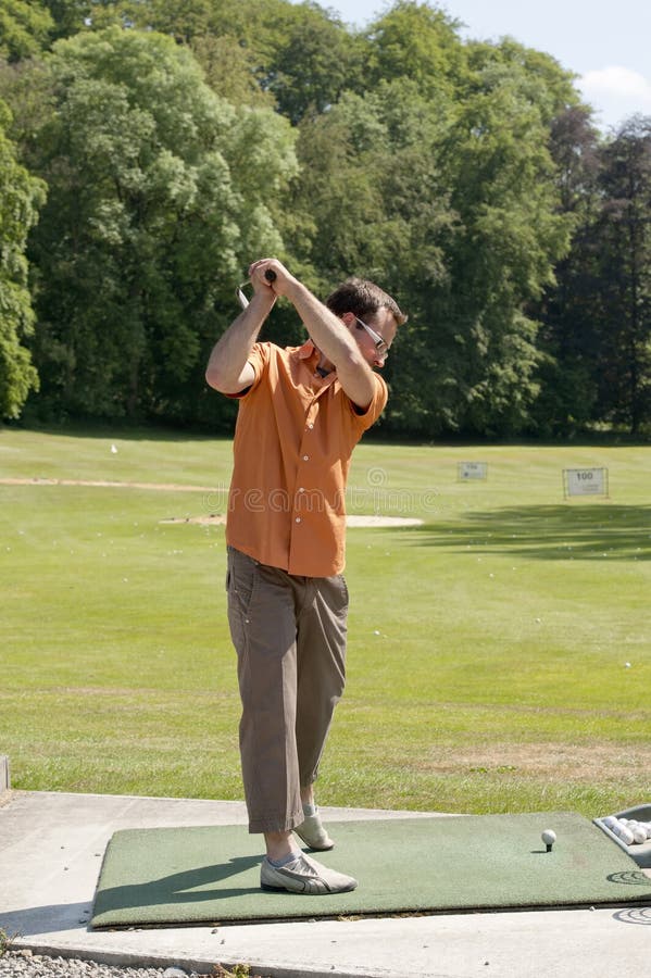 Young Man Playing Golf at the Driving Range Stock Image - Image of ...