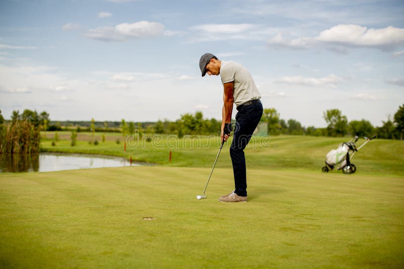 Young man playing golf stock image. Image of person - 212587773