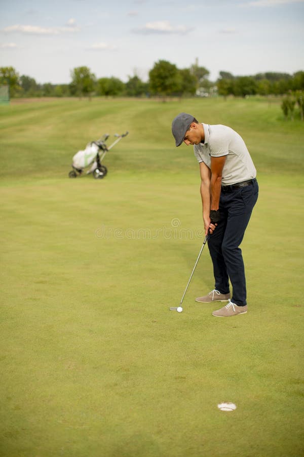Young man playing golf stock photo. Image of people - 212701820