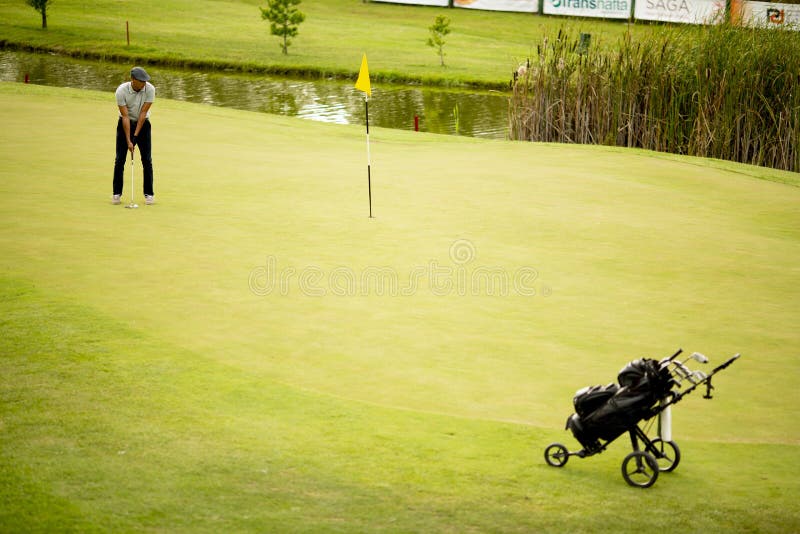 Young man playing golf stock photo. Image of green, play - 212809144