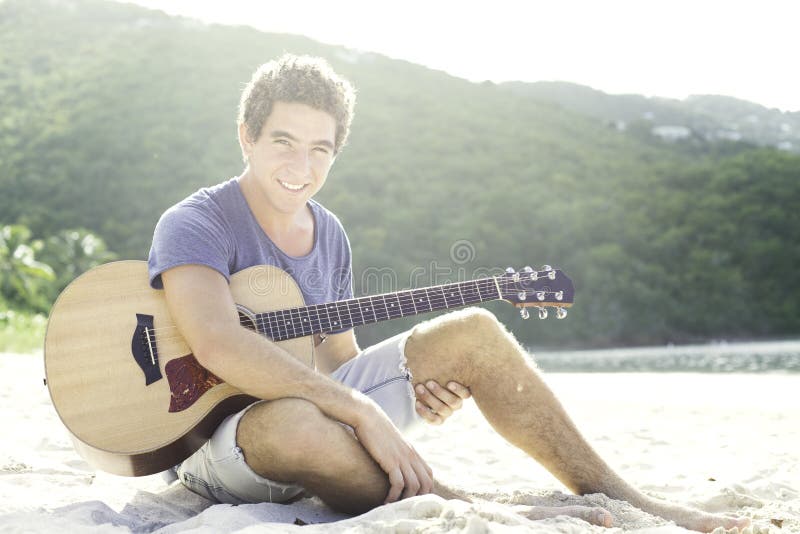 Young Man Playing Guitar on the Beach Stock Image - Image of looking ...