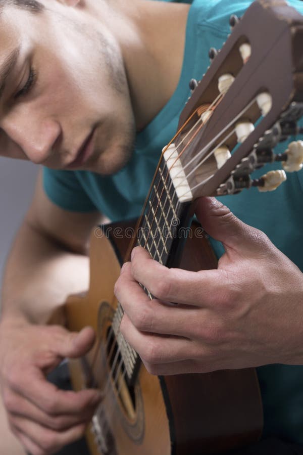 Young Man Playing Guitar stock image. Image of musical - 31980997