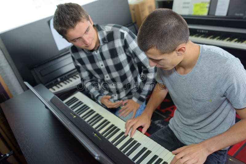 Young man playing keyboard stock photo. Image of black - 264392818