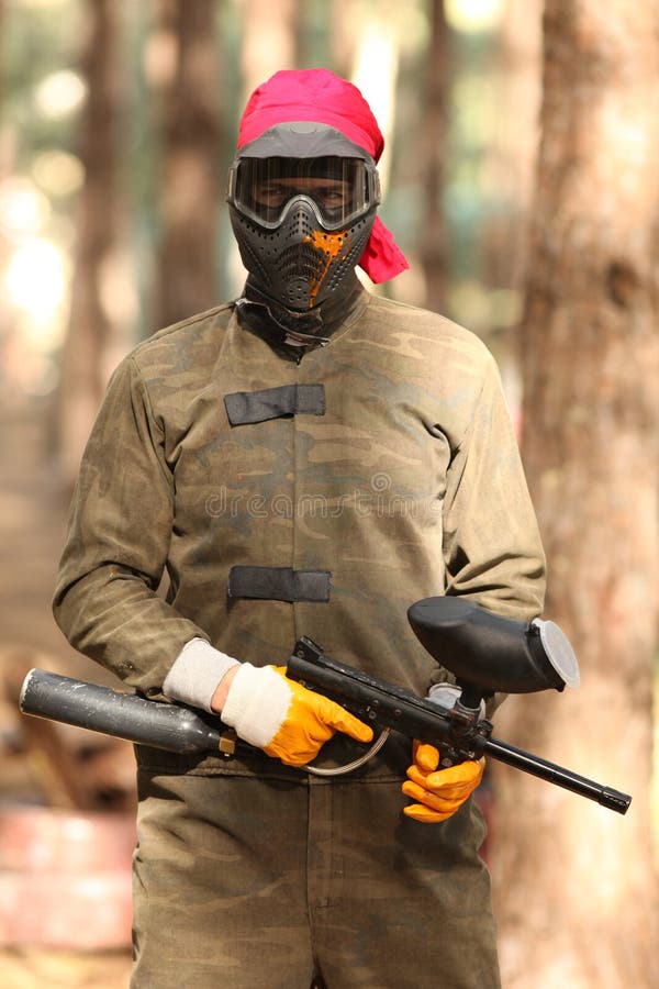 Two Young People Playing Paintball Stock Image - Image of ball, green ...