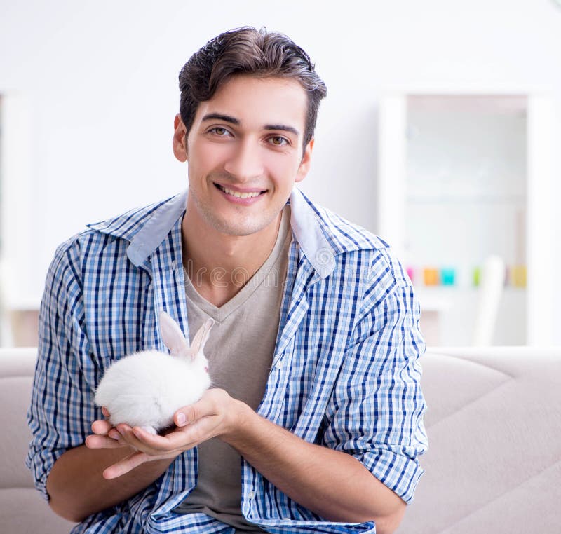 Young Man Playing with Pet Rabbit at Home Stock Image - Image of easter ...