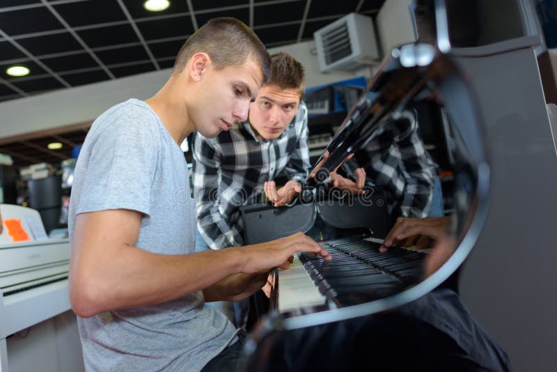 Young man playing piano stock photo. Image of pianist - 186438702