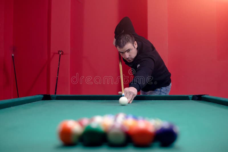 Young man is playing pool stock photo. Image of colored - 111934660