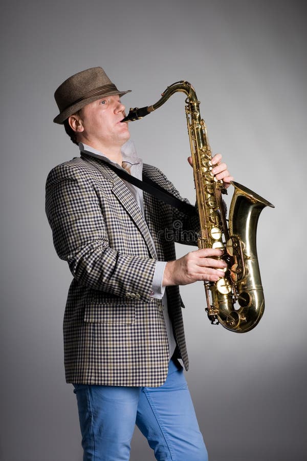 Young man playing the sax. stock photo. Image of entertainmant - 22716512