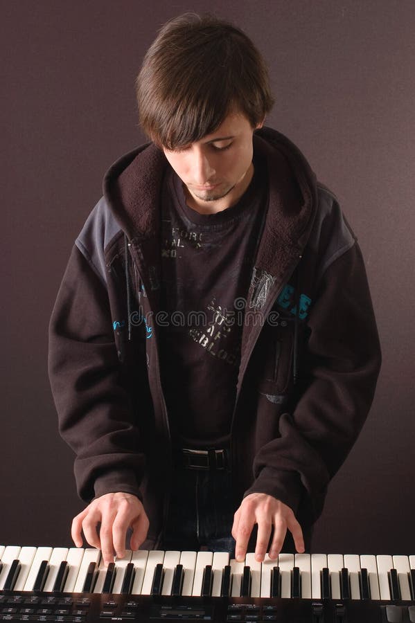 Young Man Playing on a Synthesizer Stock Photo - Image of audio ...