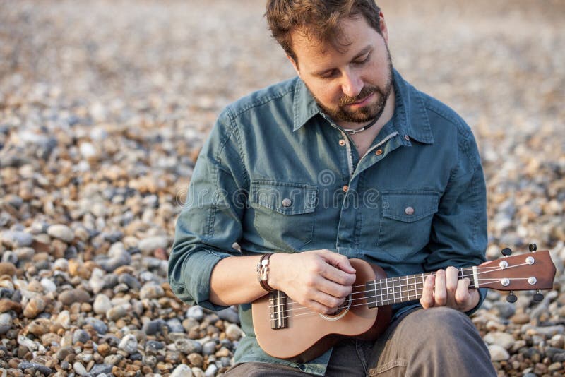 Handsome Man Playing Ukulele Stock Photo - Image of outdoors, modern ...