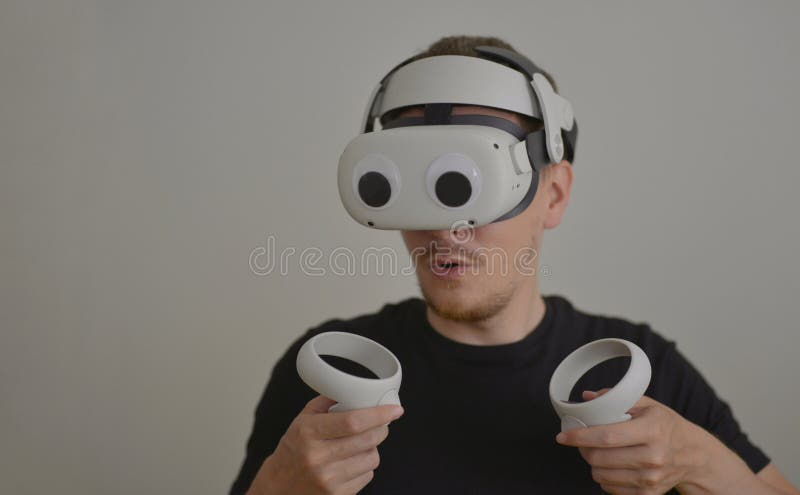 A Young Man Playing Using Visual Reality Glasses with Eye Stickers. VR ...