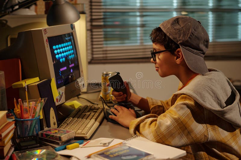 Young Man Playing Video Game on Computer at Desk Stock Photo - Image of ...
