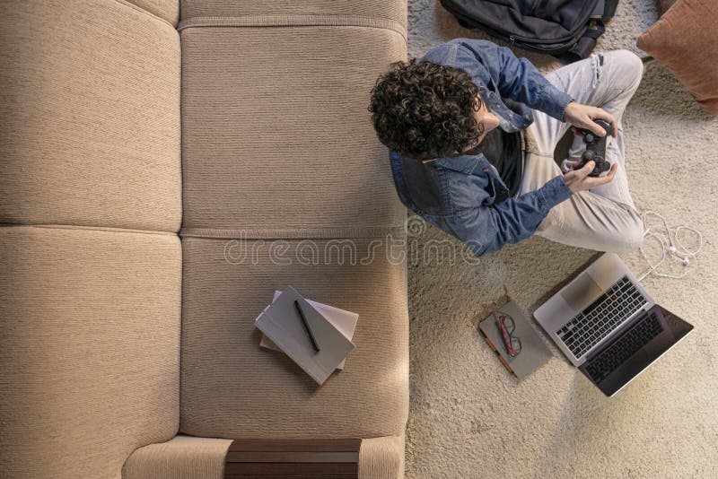 Young Man Playing Video Games during Break from His Online Classes ...
