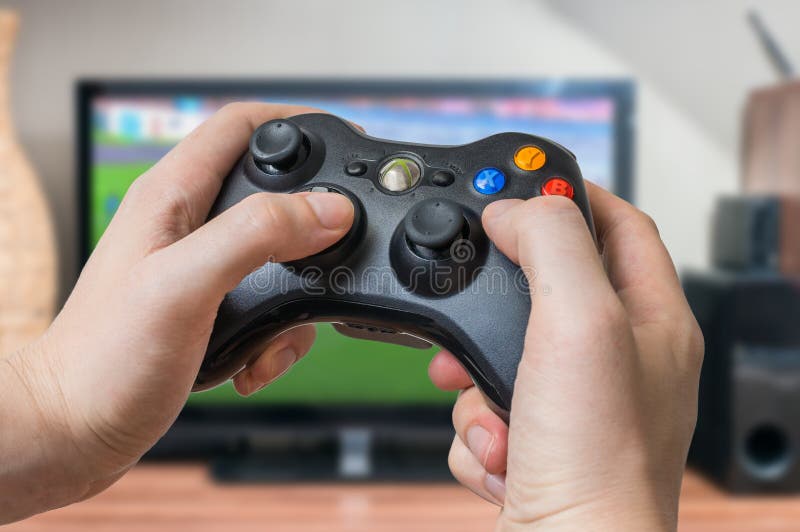 Young Man is Playing Video Games and Holds Joystick or Controller Stock ...