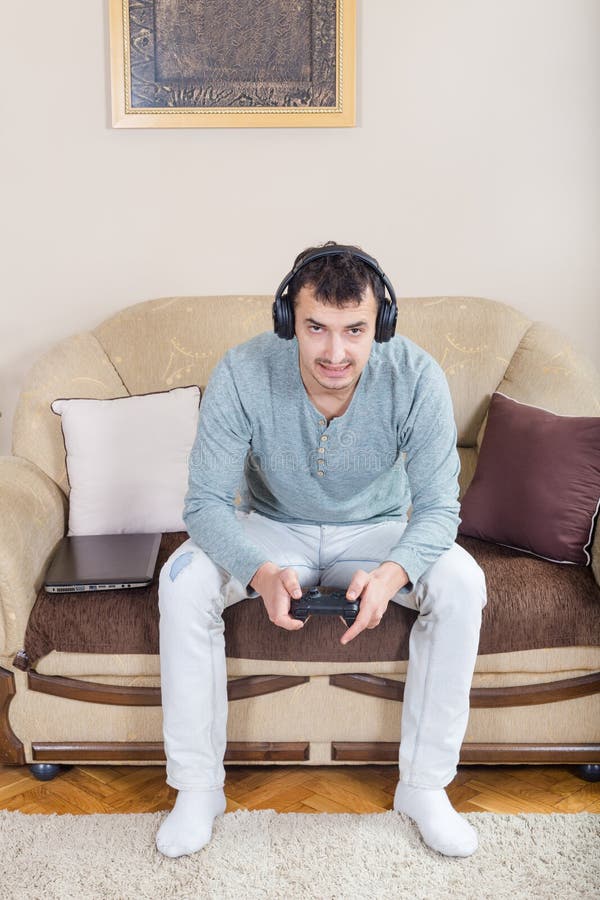 Young Man Playing Video Games with Wireless Bluetooth Joystick Stock ...