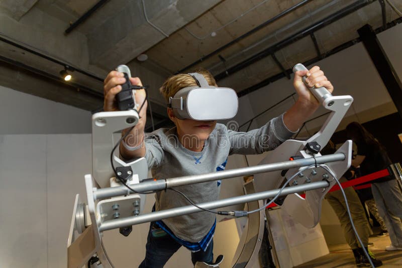 Young Man Playing Virtual Reality Fly Simulator at Technology ...