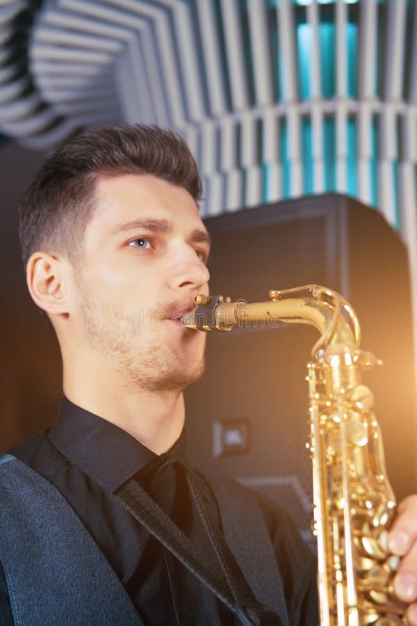 Young Man Plays a Musical Instrument Saxophone Stock Image - Image of ...
